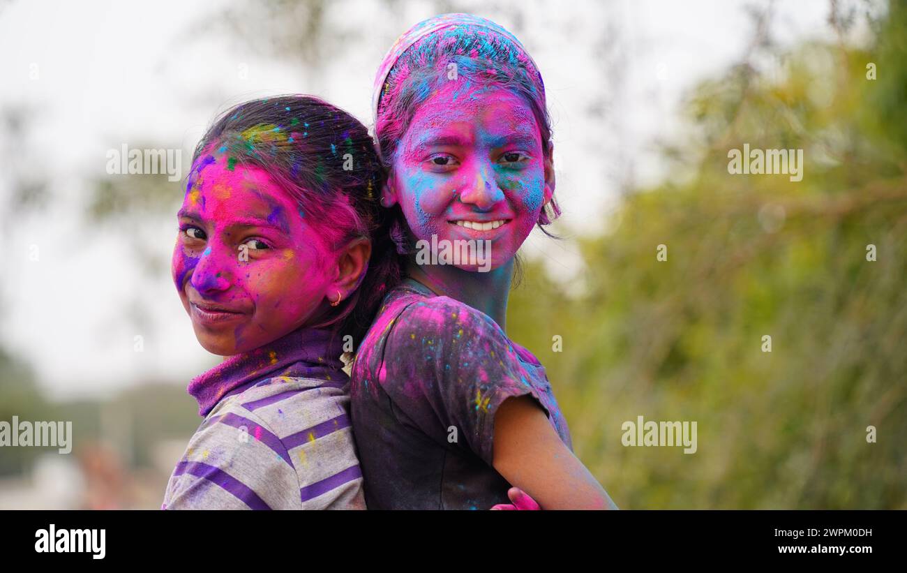 Happy Indian friends or kids celebrating the Hindu festival of Holi by ...