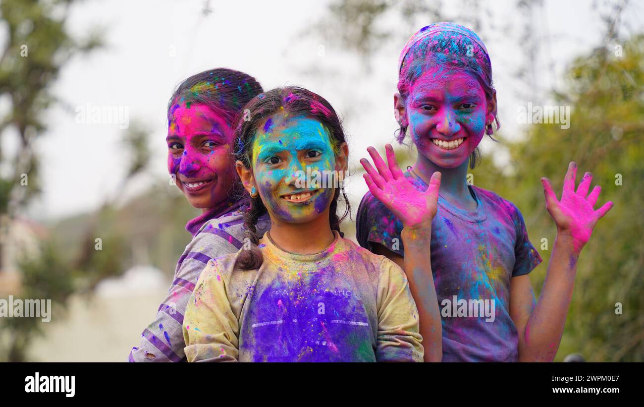 Young cute cheerful little kids with applied holi colors powder showing ...