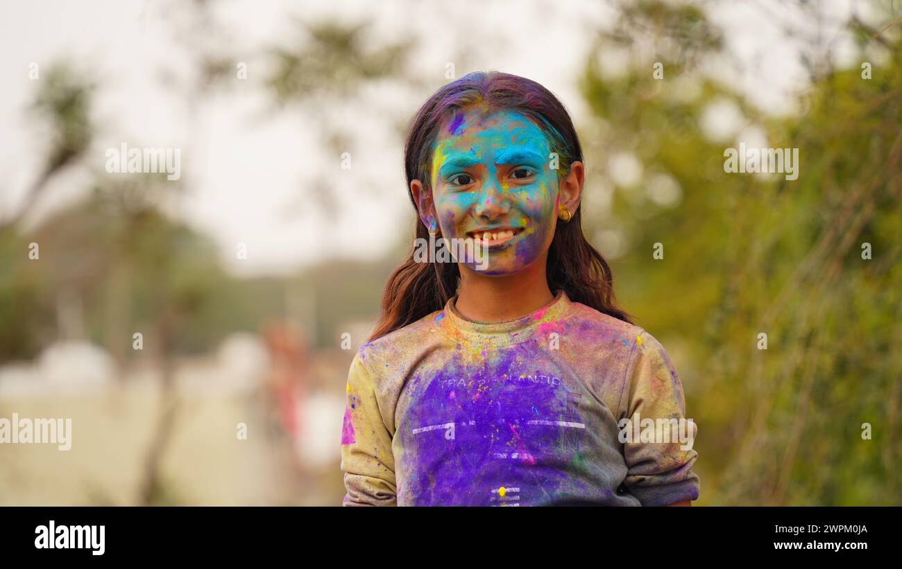 Children covered in colored powder during the festival of Holi. Happy ...