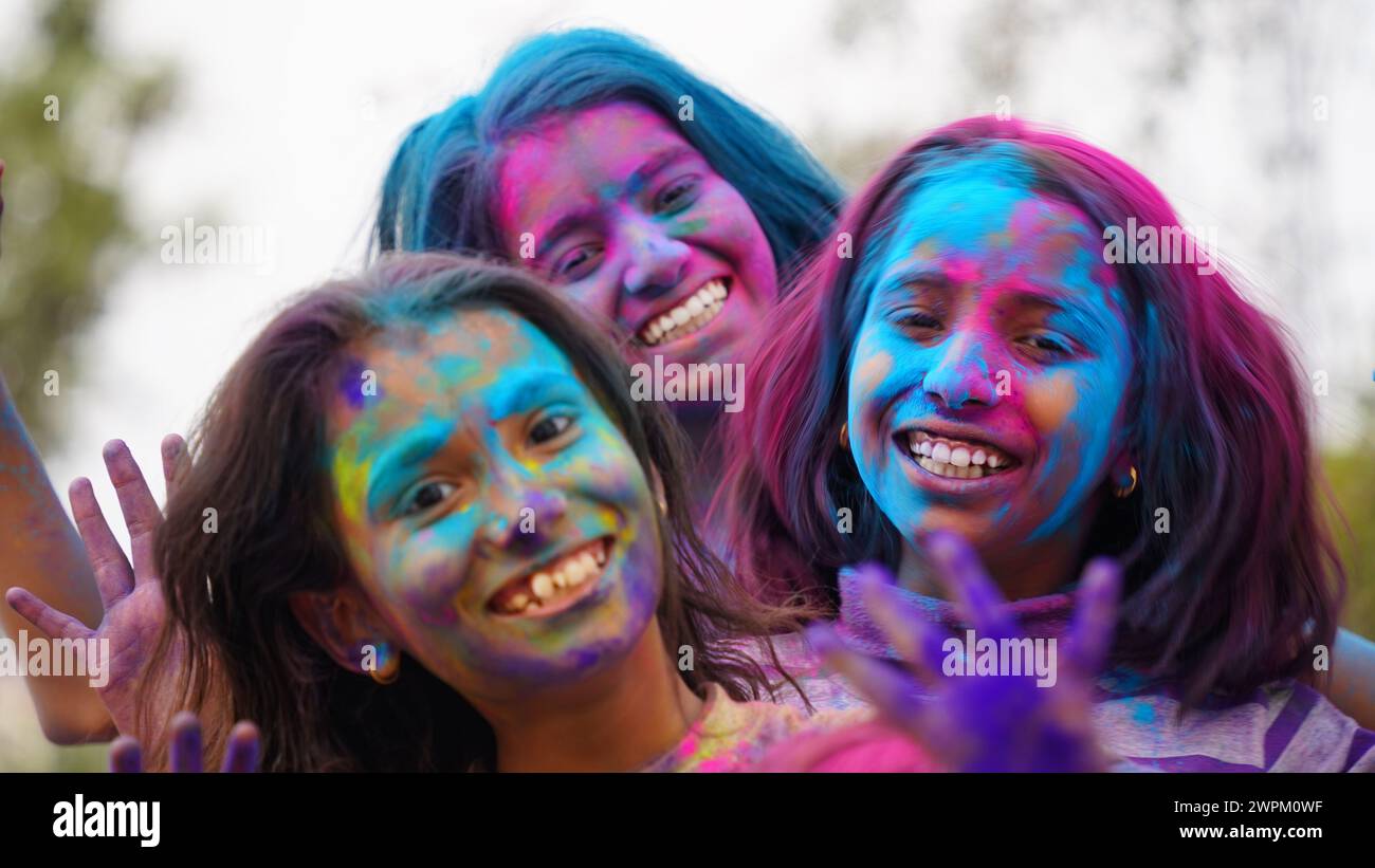 Young cute cheerful little girl kid with applied holi colors powder ...