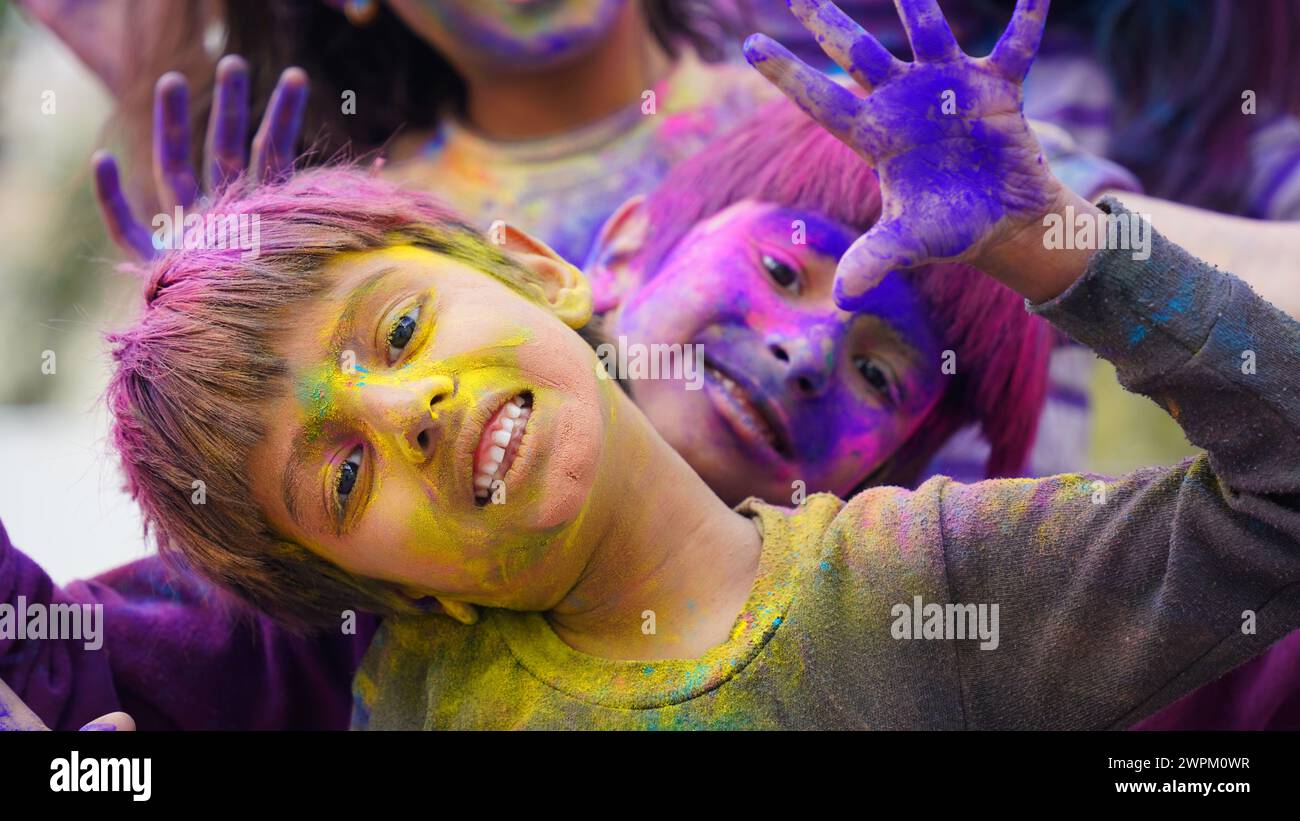 Children covered in colored powder during the festival of Holi. Happy ...