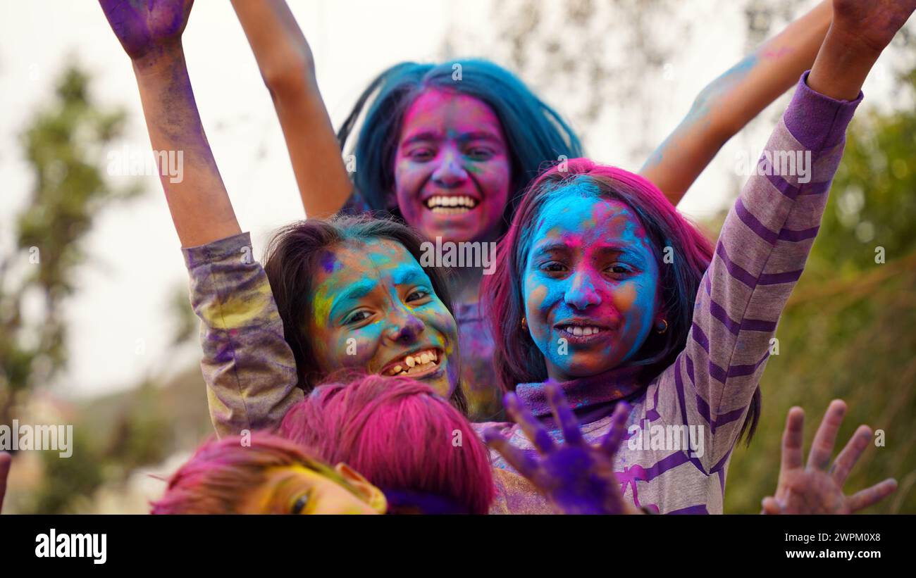 Happy Indian kids playing colours, smiling with colors on face or asian ...