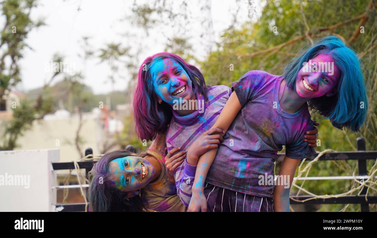 Happy Indian friends or kids celebrating the Hindu festival of Holi by ...