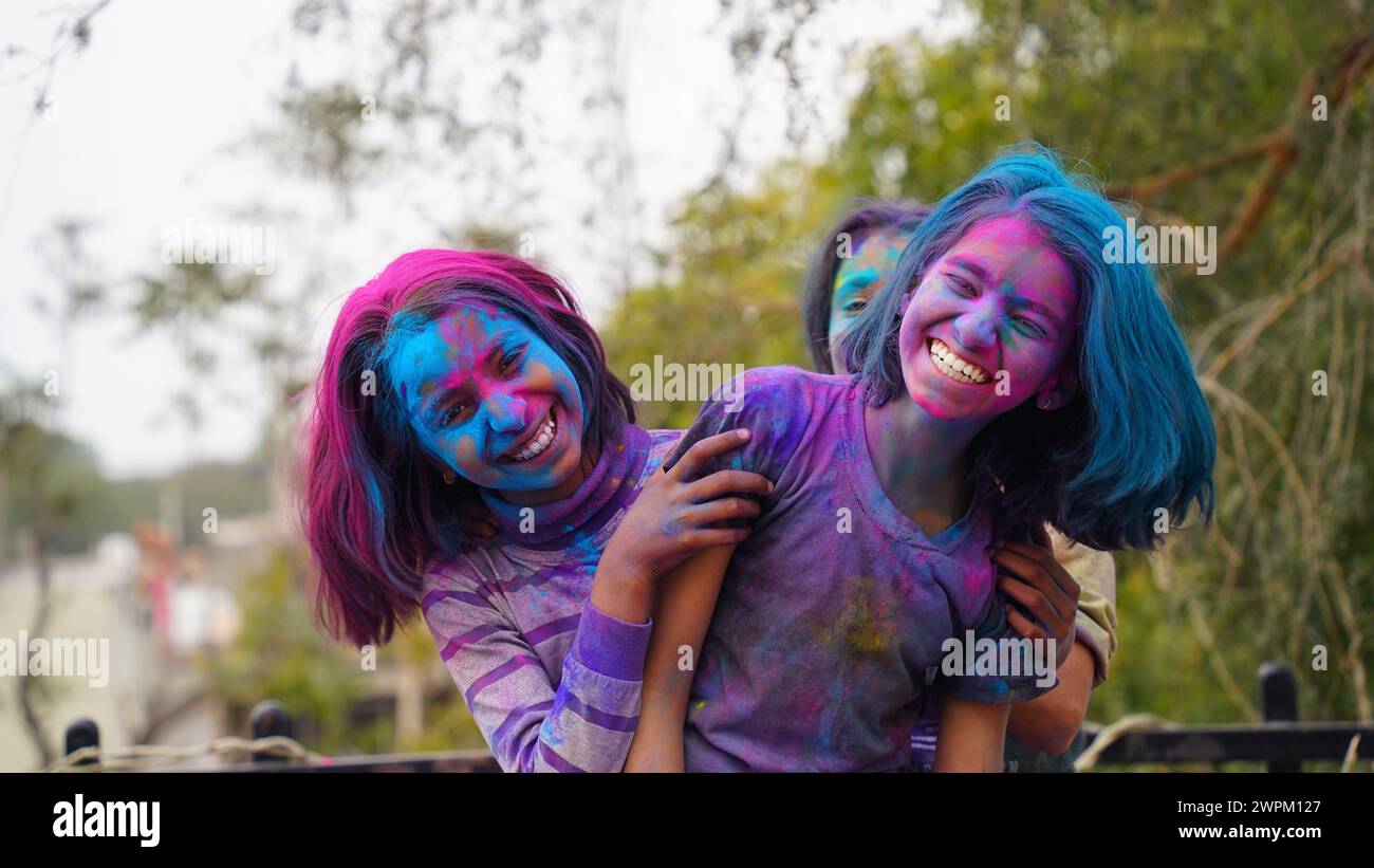 Children covered in colored powder during the festival of Holi. Happy ...