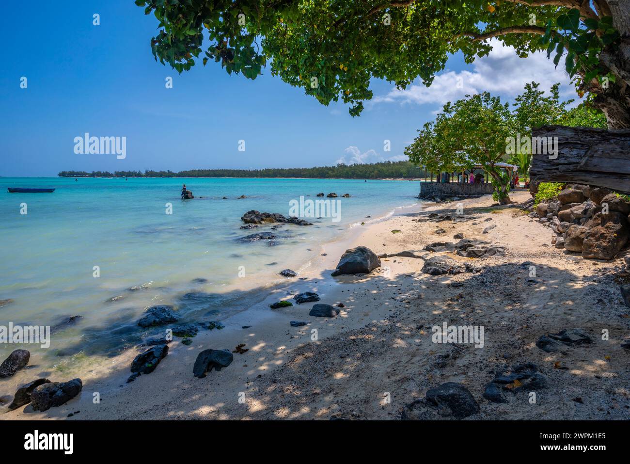 View of man fishing from Mont Choisy Beach and turquoise Indian Ocean ...