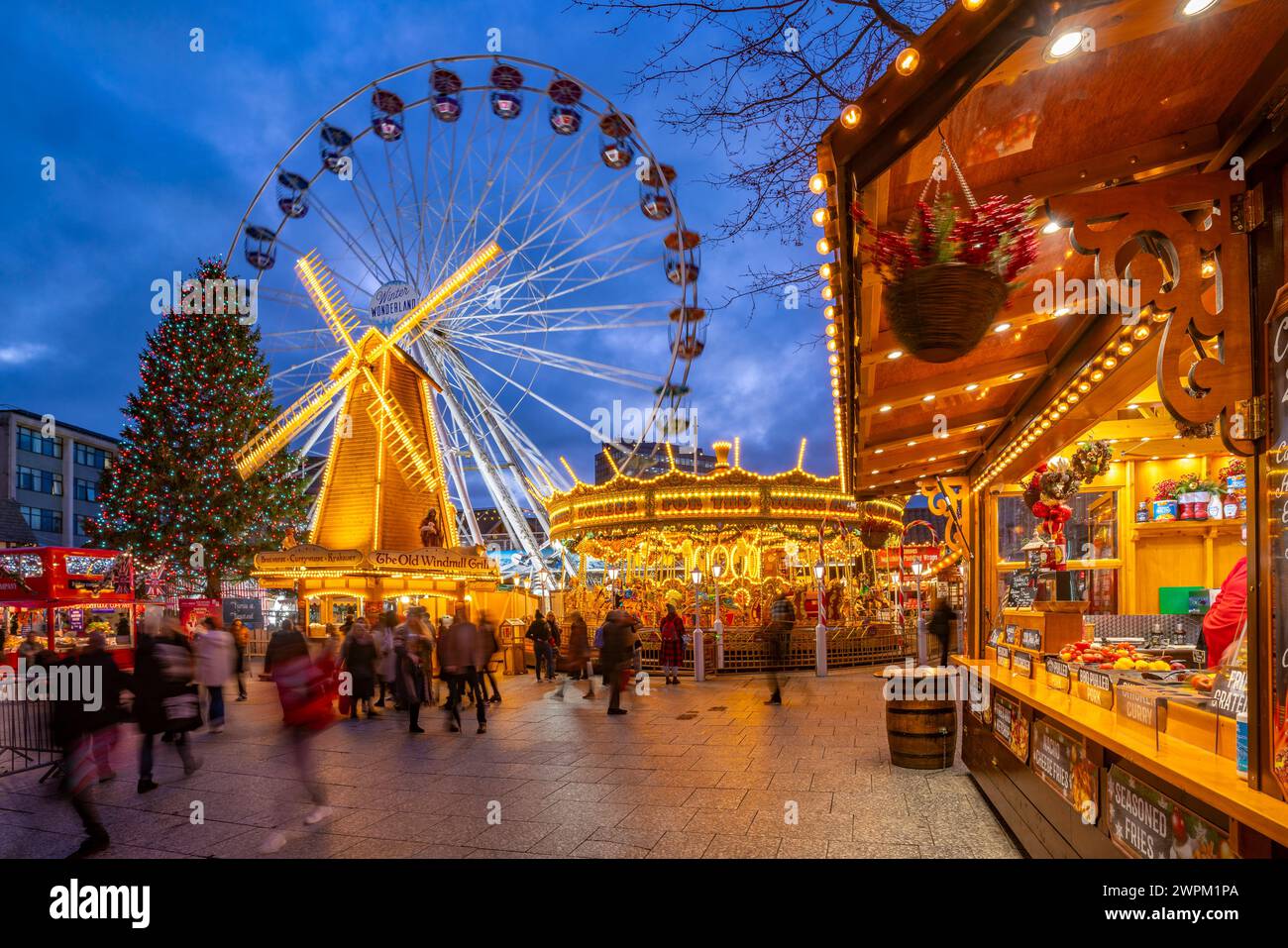View of ferris wheel and Christmas Market on Old Market Square at dusk ...