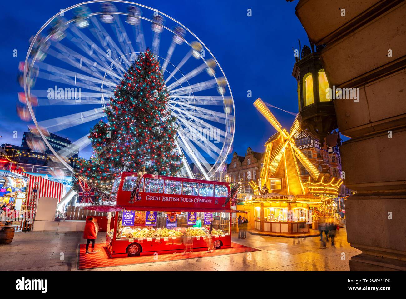 View of ferris wheel and Christmas Market on Old Market Square at dusk ...