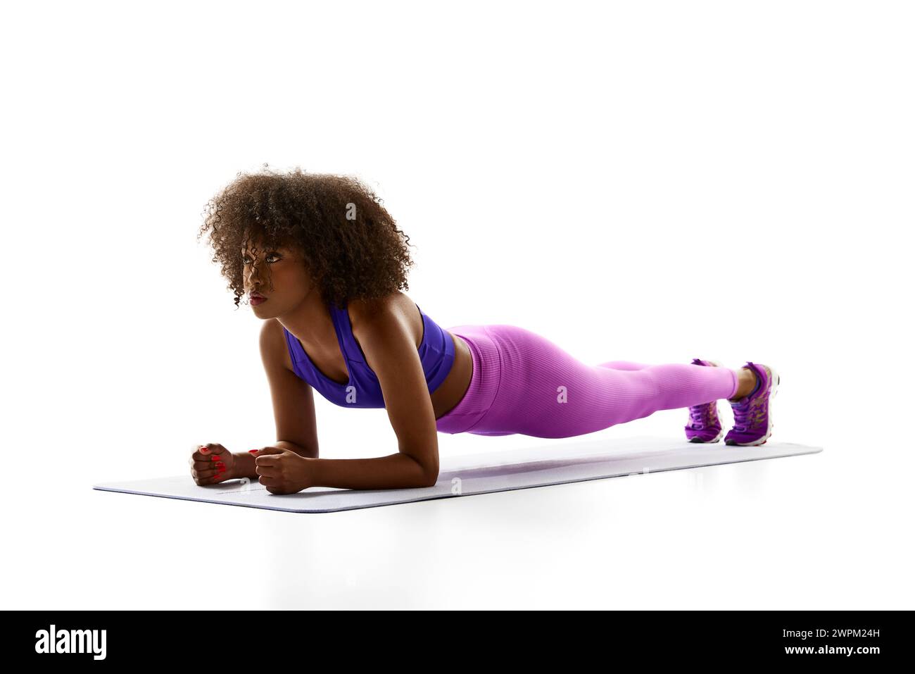 Strength and power. Young African-American woman stands in plank ...