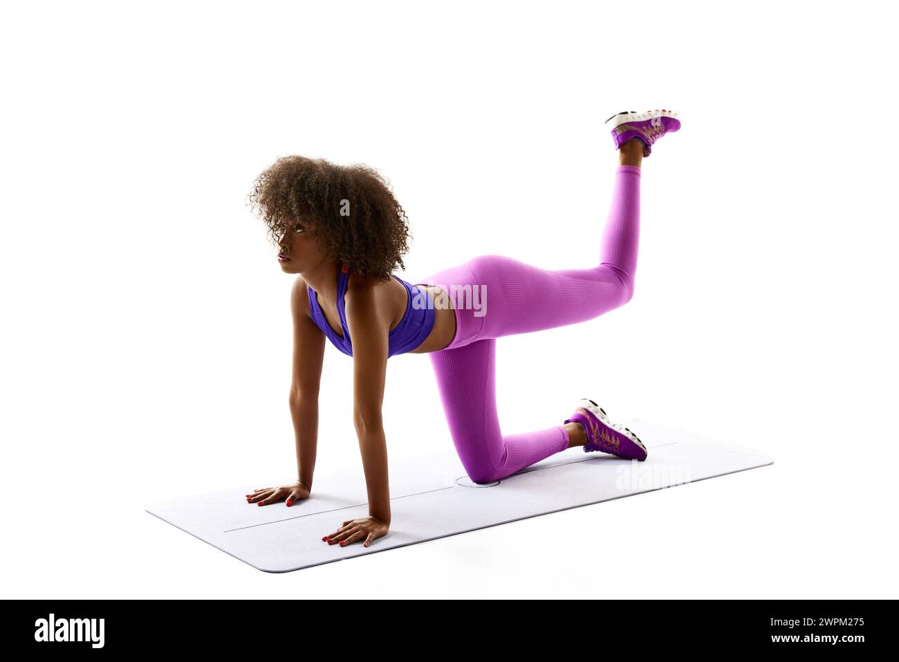 Young African-American woman training leg muscles, buttocks against ...