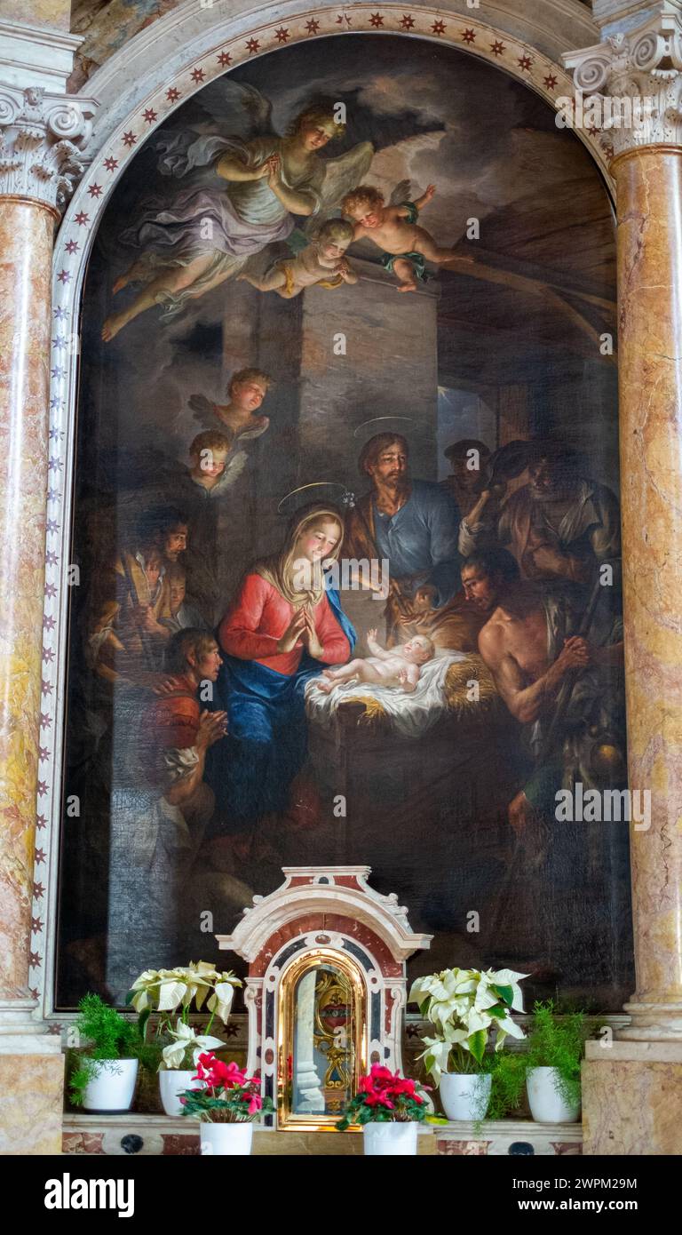 Painting of baby Jesus in the cradle with Mary at his side Stock Photo ...