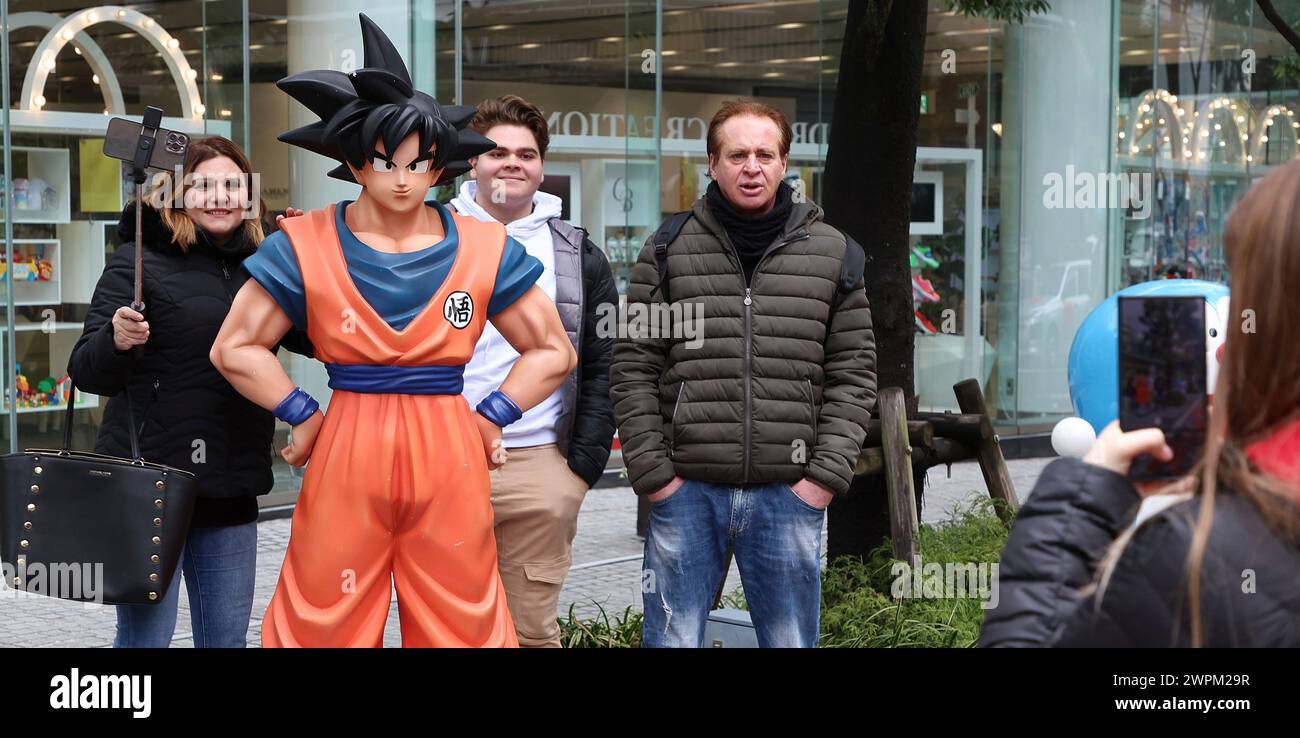 People take a photo with a statue of Son Goku, a protagonist of Dragon ...