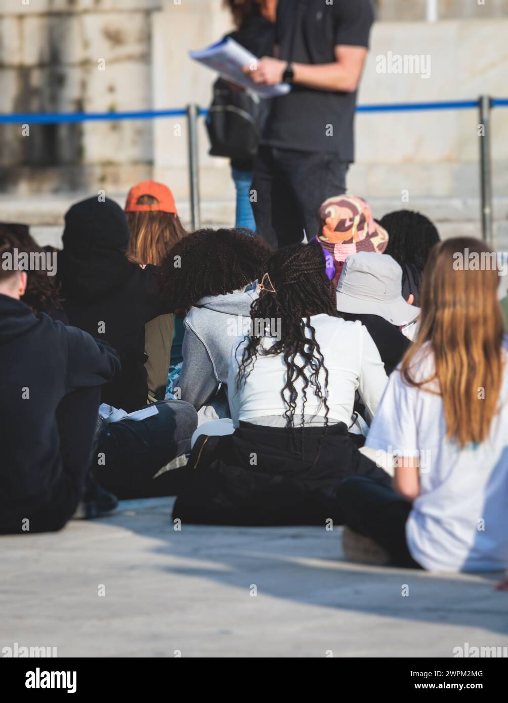 Group of tourists sitting during outdoor excursion tour in the city ...