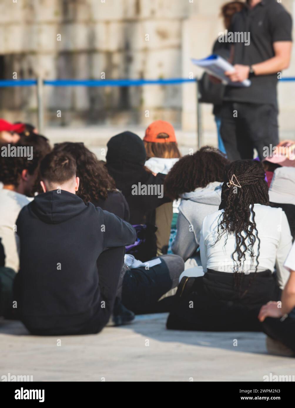Group of tourists sitting during outdoor excursion tour in the city ...