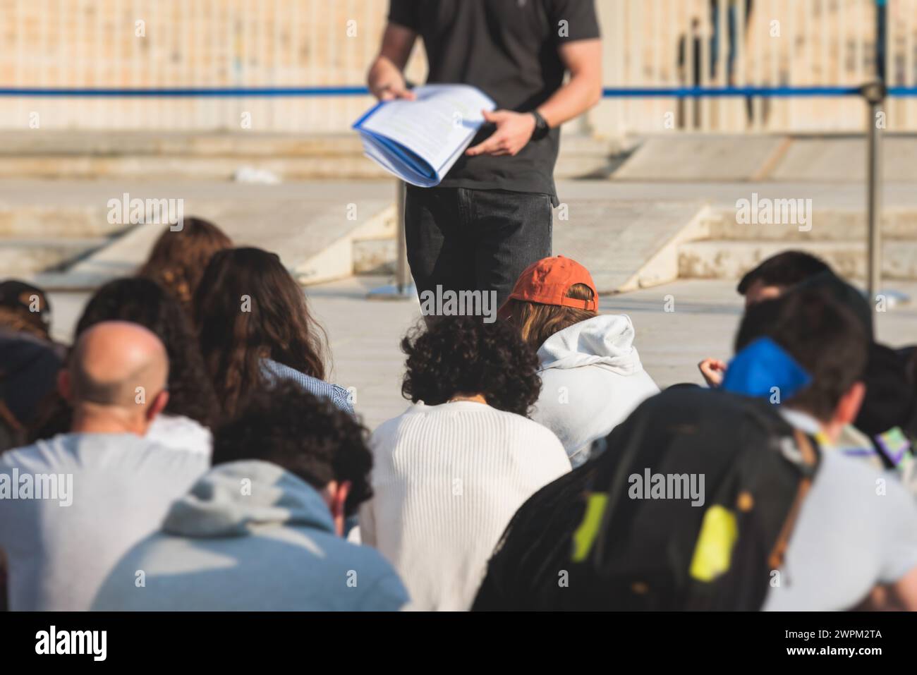 Group of tourists sitting during outdoor excursion tour in the city ...