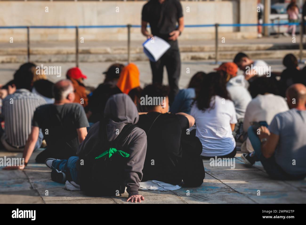 Group of tourists sitting during outdoor excursion tour in the city ...