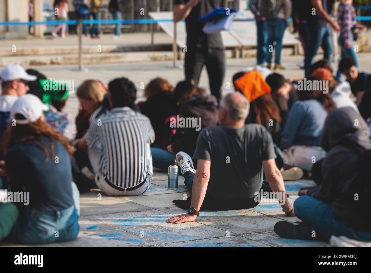 Group of tourists sitting during outdoor excursion tour in the city ...