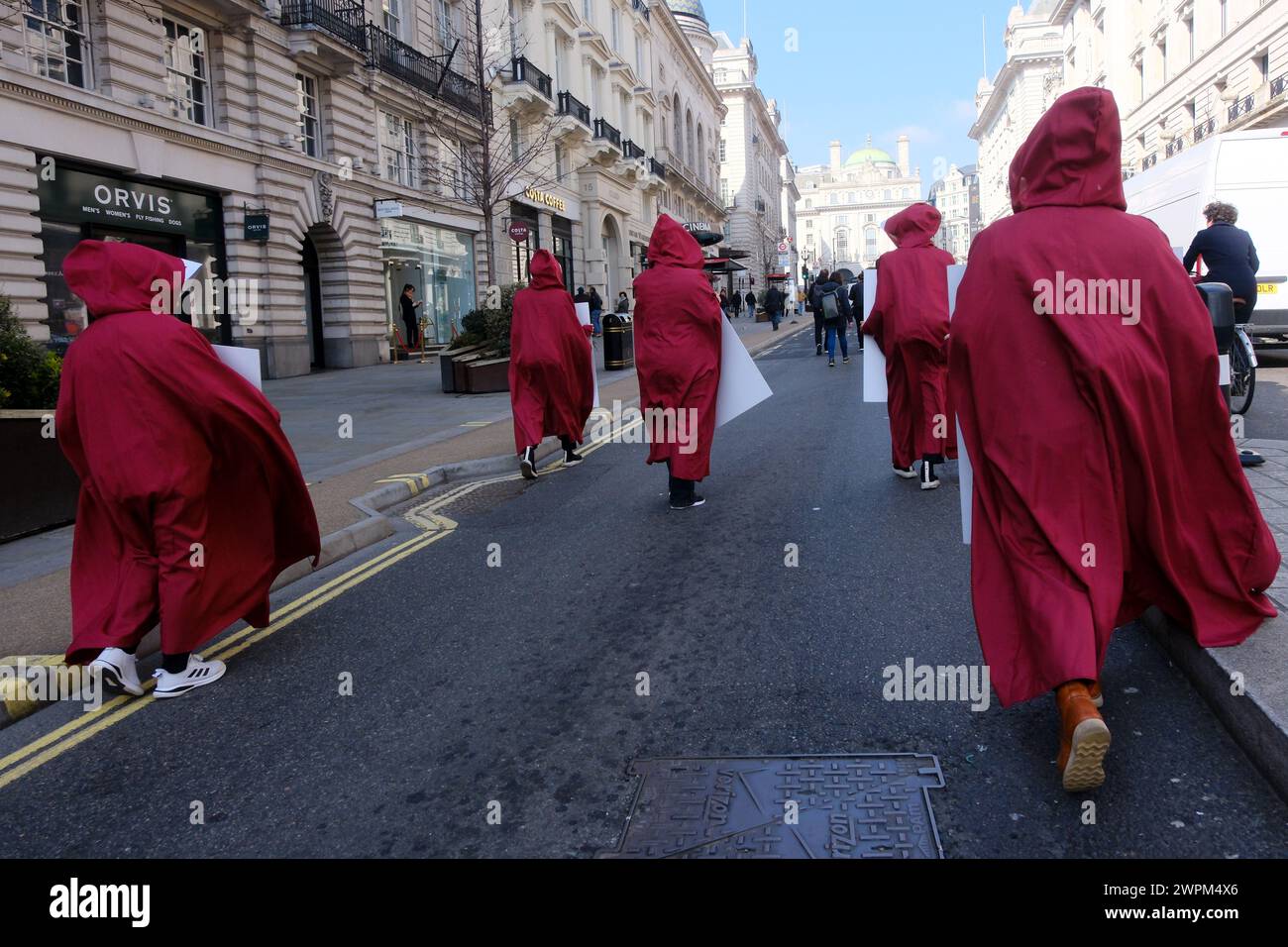 London, UK. 8th Mar 2024. Iranian women wearing the Handmaid's Tale red ...