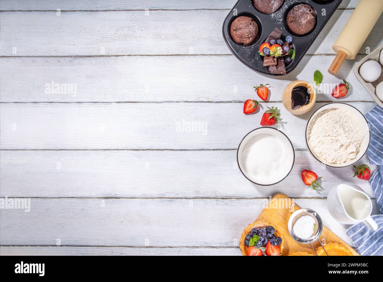 Summer baking background with baked pastry - berry cakes, muffins, mini ...