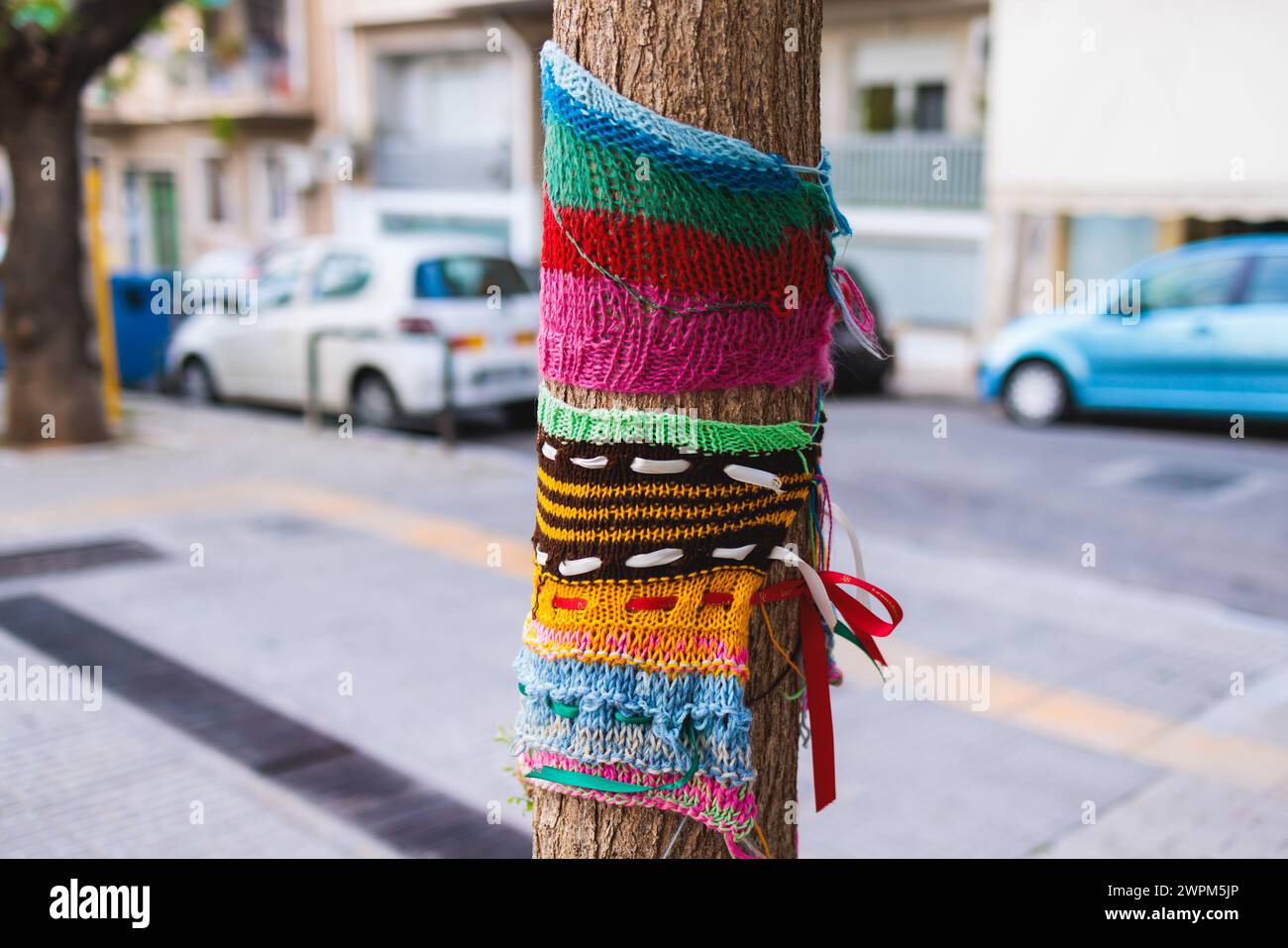 Yarnbombing, trees decorated with yarn bombing, knitted graffiti street ...