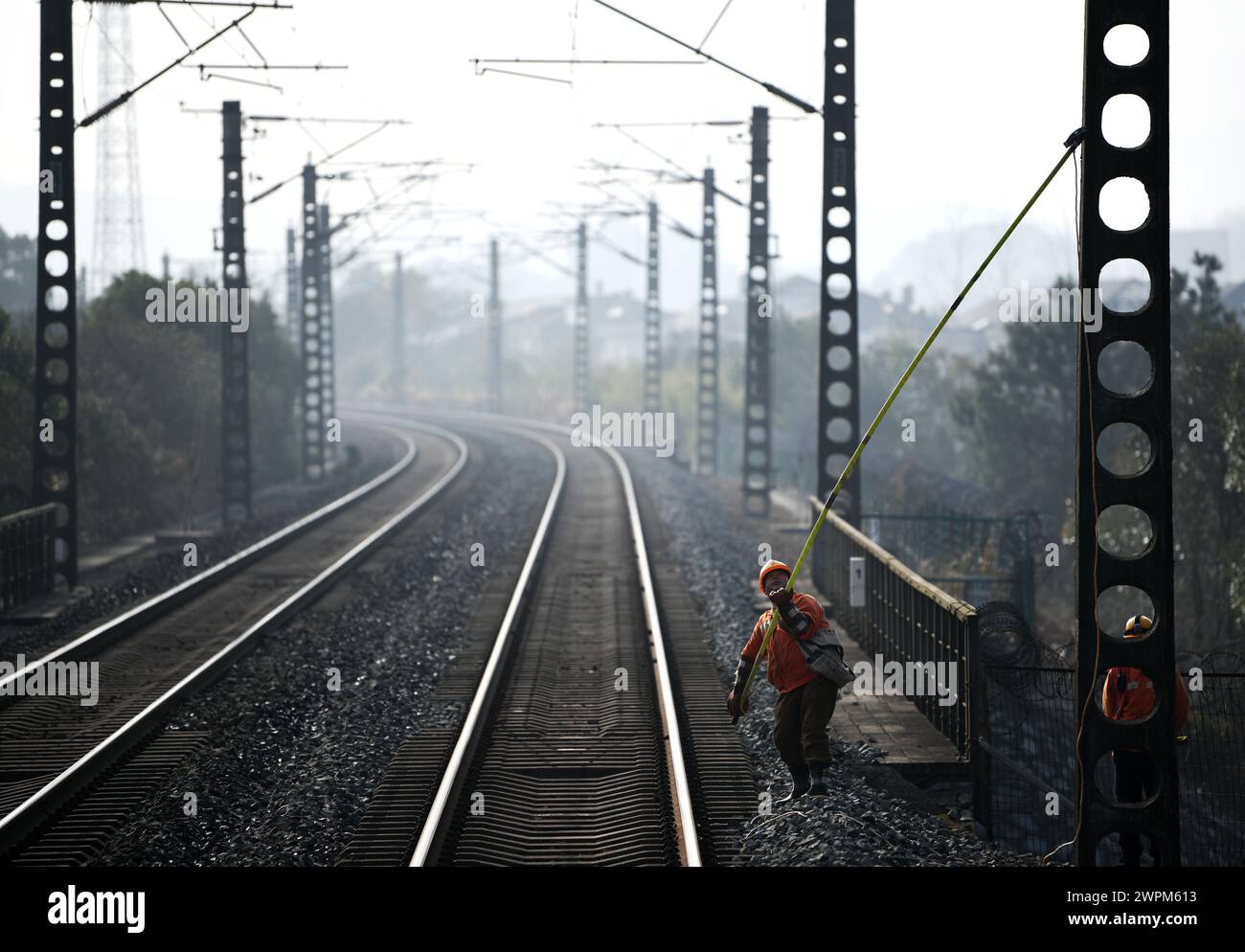 JIUJIANG, CHINA - MARCH 8, 2024 - An overhead contact line worker at ...
