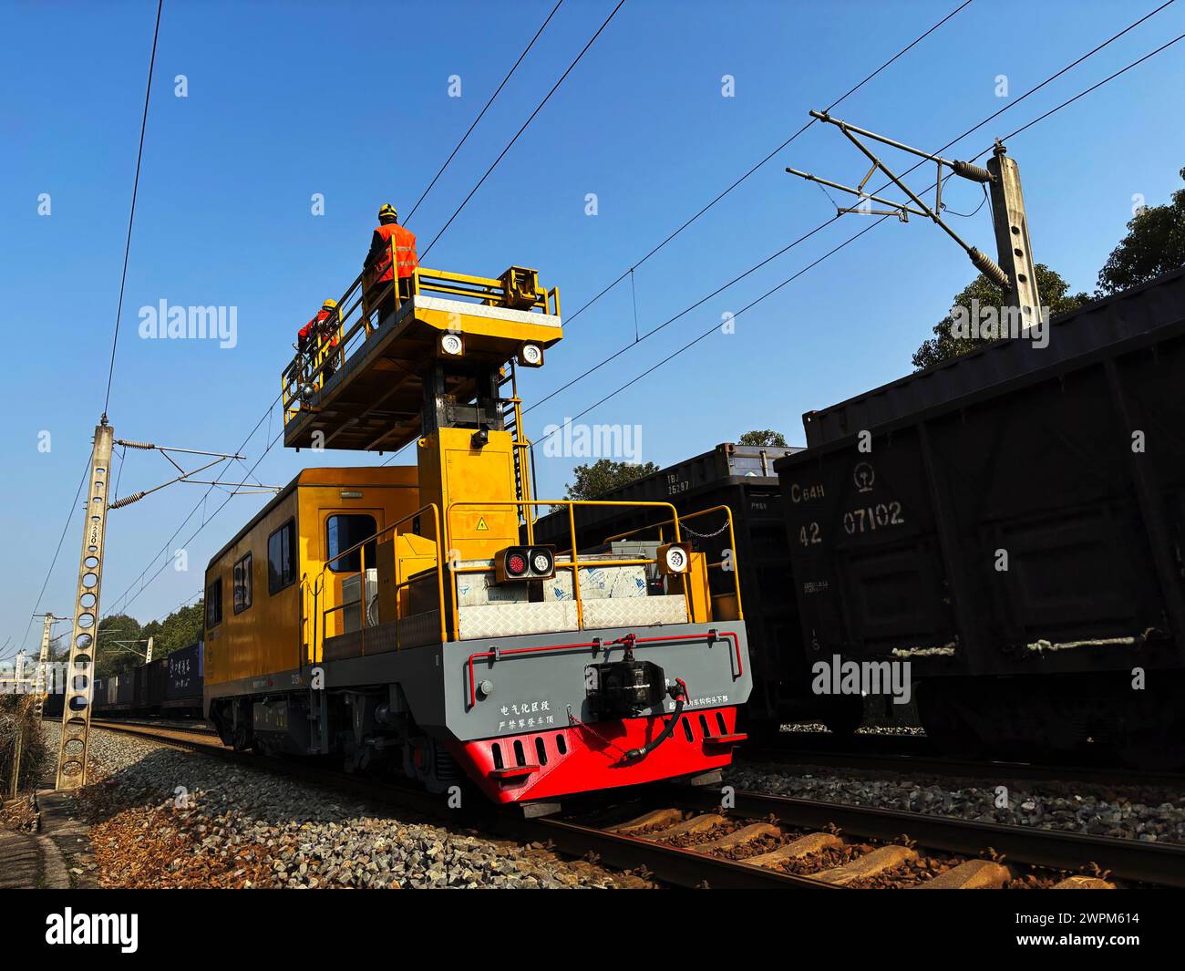 JIUJIANG, CHINA - MARCH 8, 2024 - Overhead contact line workers of ...