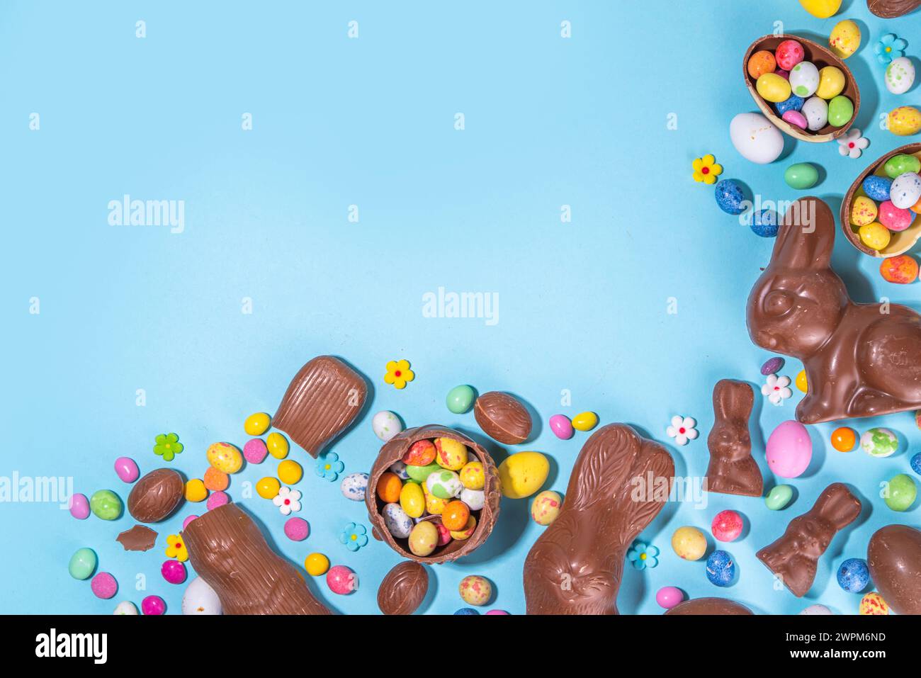Easter chocolate egg and bunny background. High-colored flat lay with ...