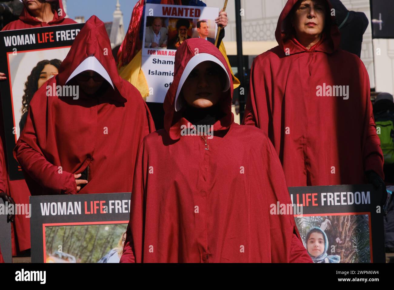 London, UK. 8th Mar 2024. Iranian women wearing the Handmaid's Tale red ...