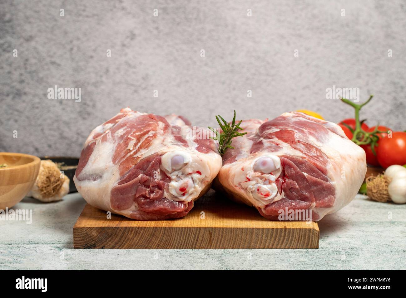 leg of lamb Butcher products. Raw lamb leg meat with bones on stone ...