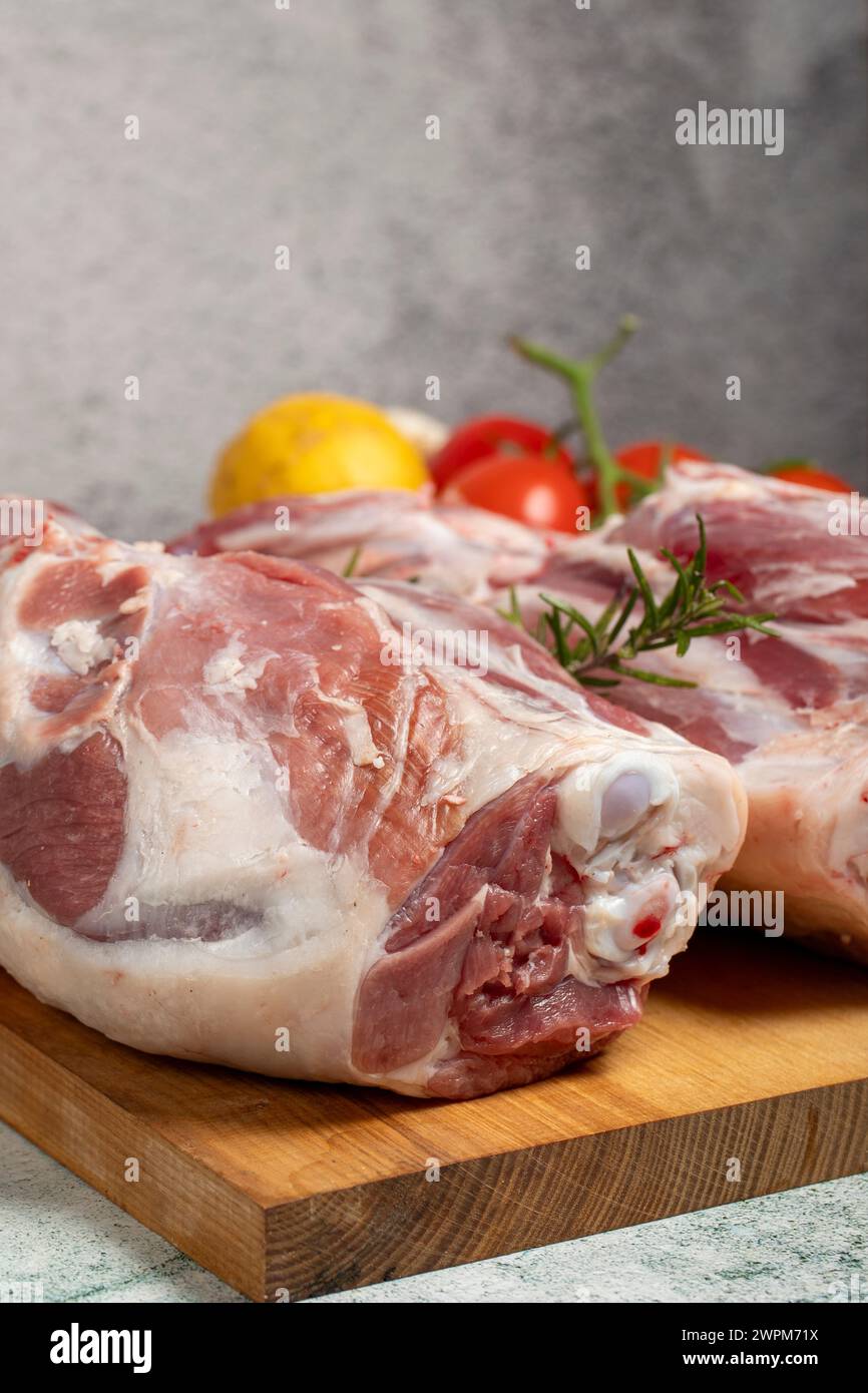 leg of lamb Butcher products. Raw lamb leg meat with bones on stone ...