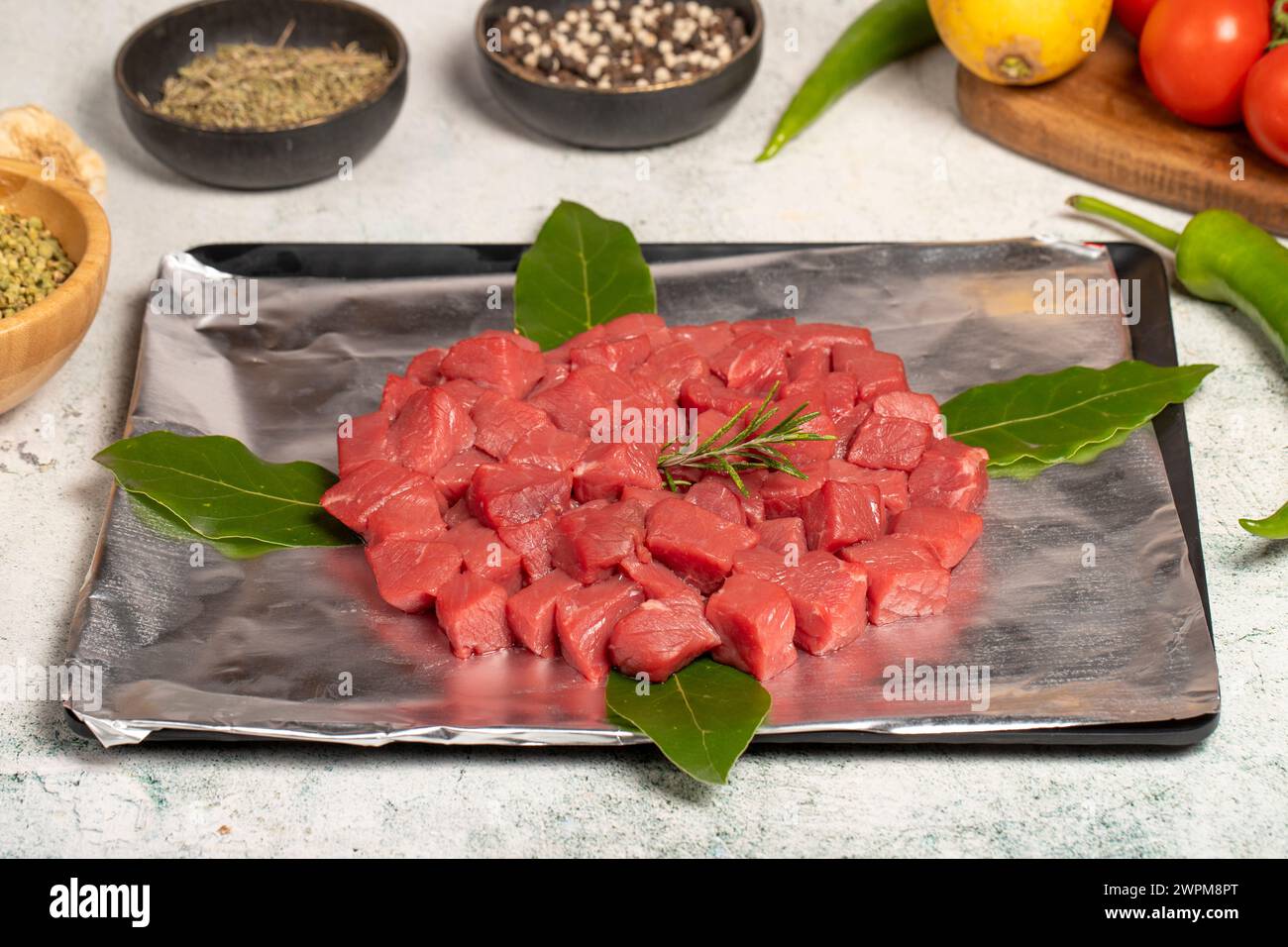 Beef cubed meat. Butcher products. Chopped raw beef on stone background ...