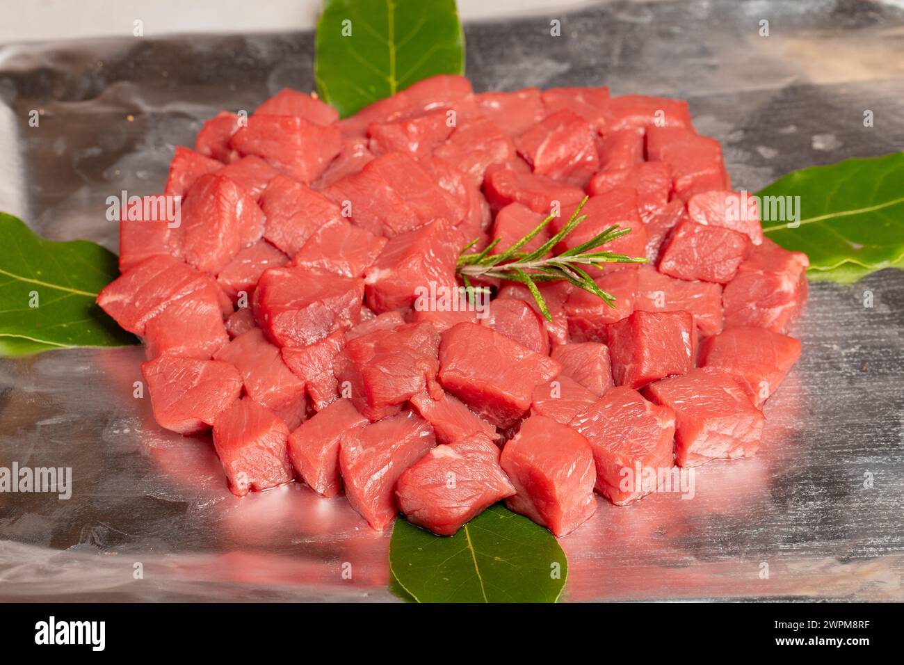 Beef cubed meat. Butcher products. Chopped raw beef on stone background ...
