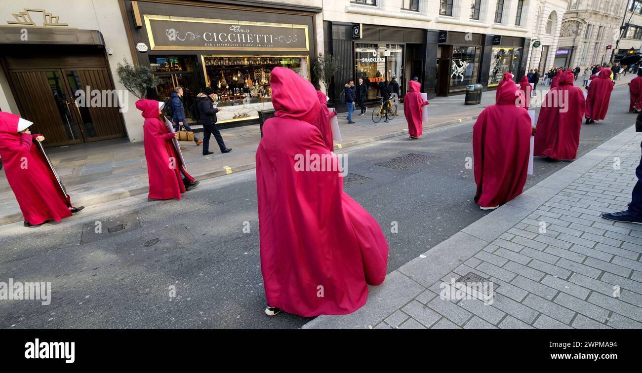 London, UK. 8th Mar 2024. Iranian women wearing the Handmaid's Tale red ...