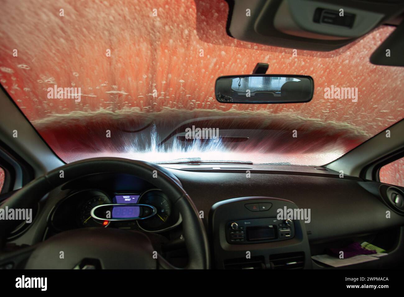 Car in a carwash. View from inside a car as it progresses through an ...