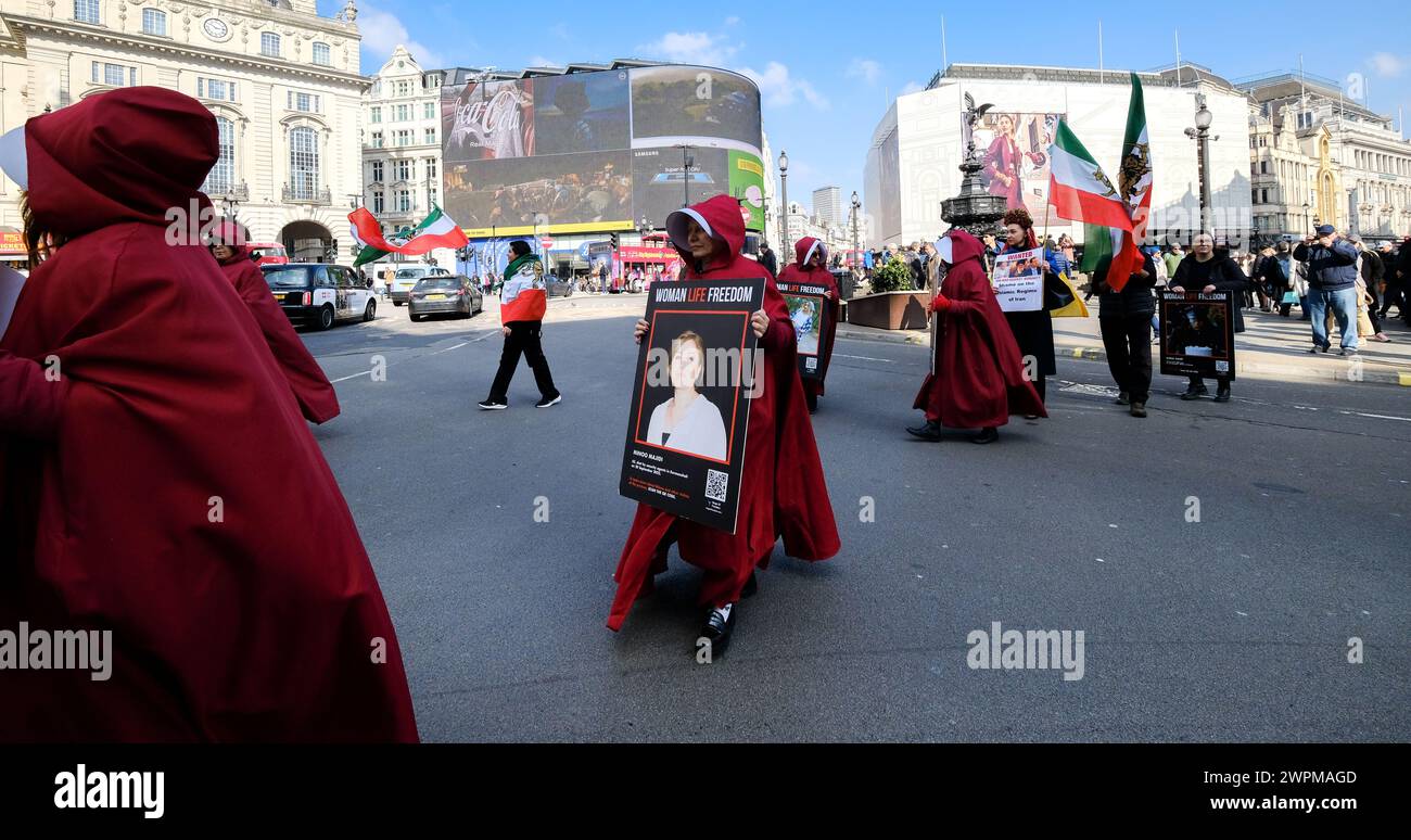 London, UK. 8th Mar 2024. Iranian women wearing the Handmaid's Tale red ...