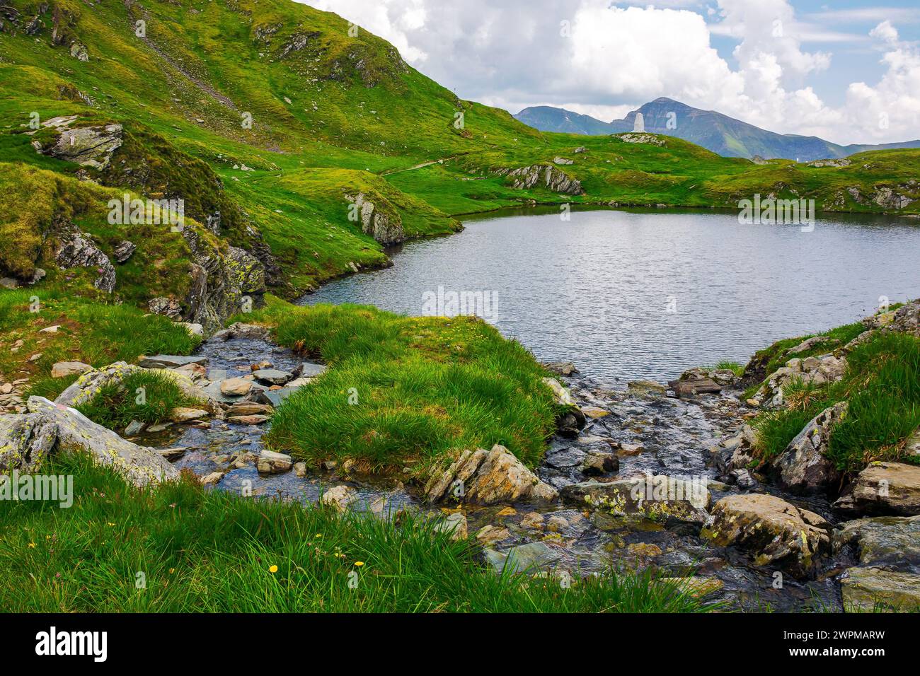 capra lake of fagaras range on a cloudy day. summer nature background ...