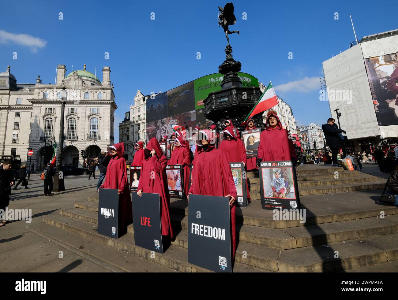 London, UK. 8th Mar 2024. Iranian women wearing the Handmaid's Tale red ...
