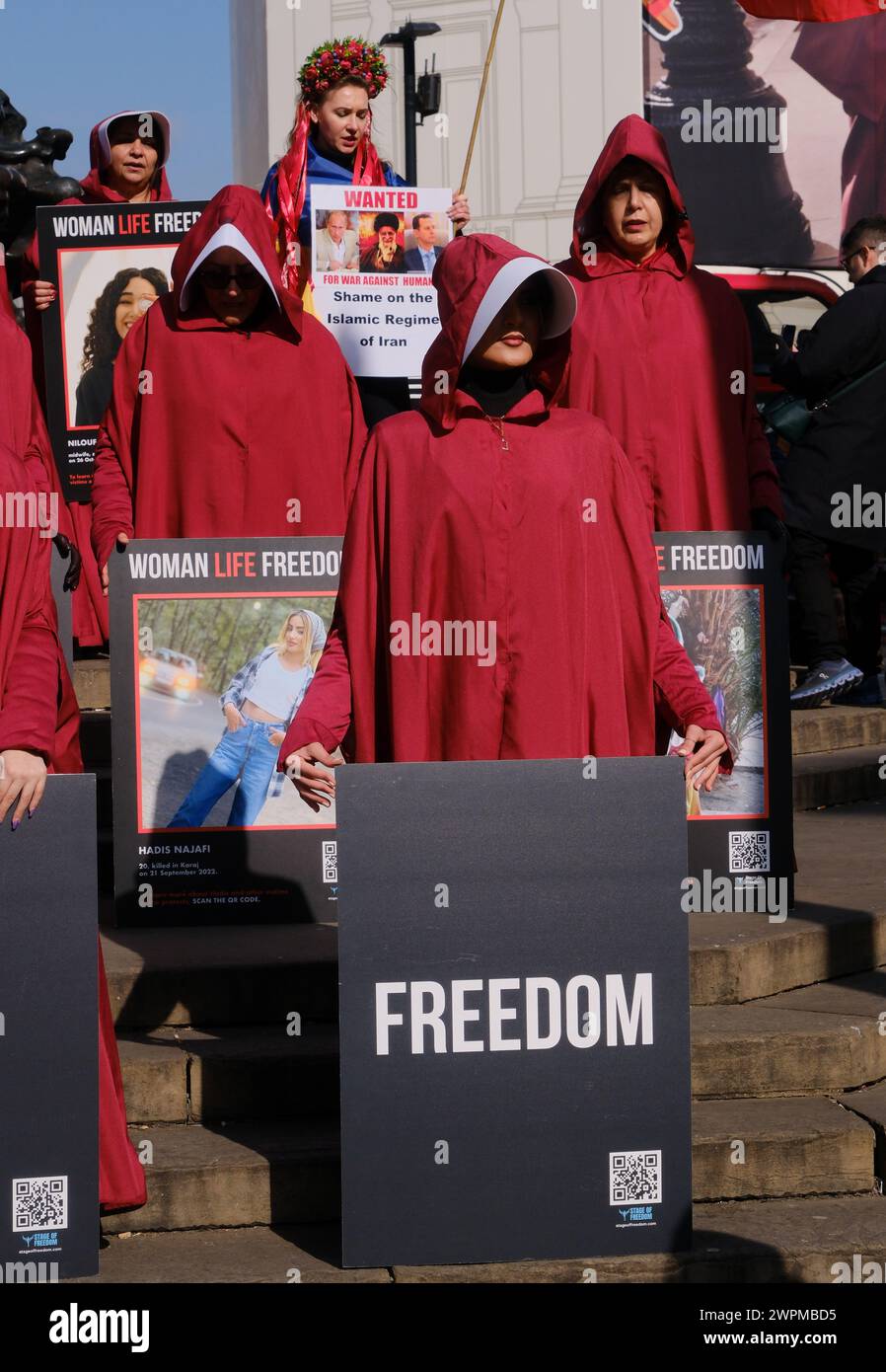 London, UK. 8th Mar 2024. Iranian women wearing the Handmaid's Tale red ...