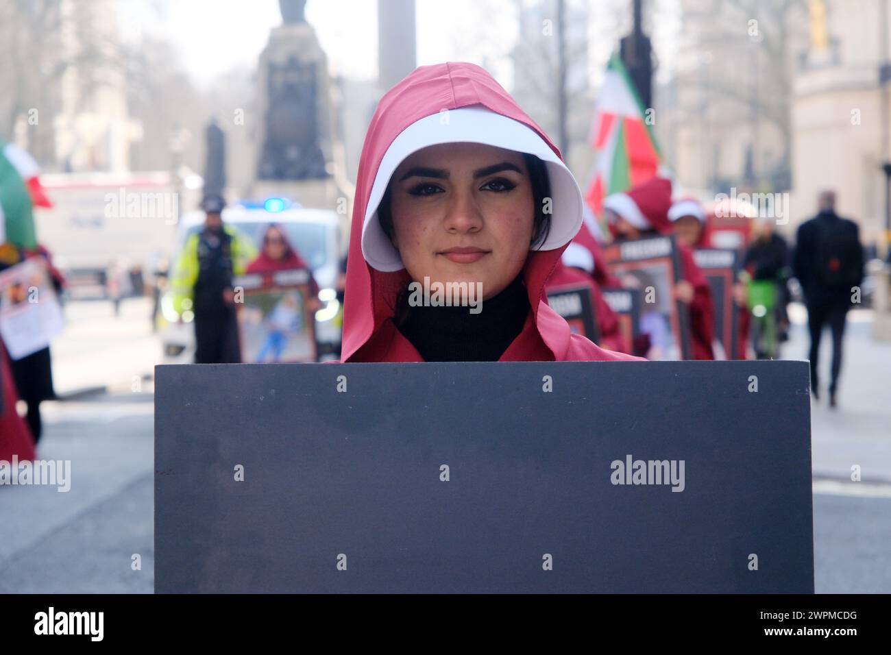 London, UK. 8th Mar 2024. Iranian women wearing the Handmaid's Tale red ...