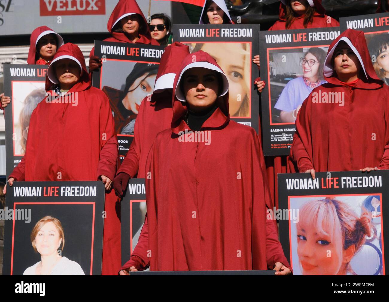 London, UK. 8th Mar 2024. Iranian women wearing the Handmaid's Tale red ...
