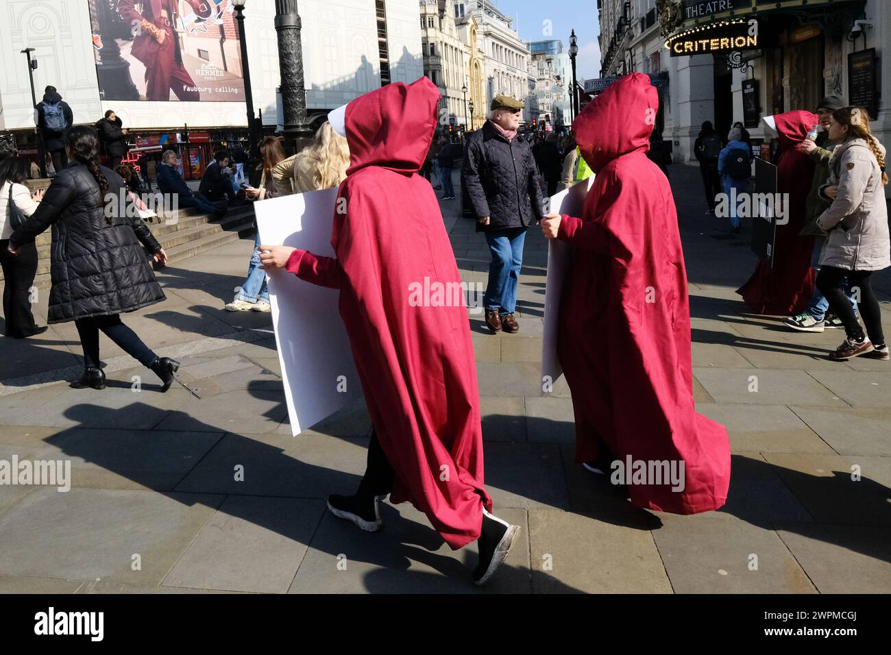 London, UK. 8th Mar 2024. Iranian women wearing the Handmaid's Tale red ...