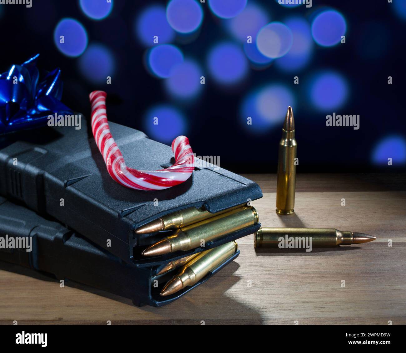 Candy cane and blue bow on top of loaded AR-15 magazines with blue ...