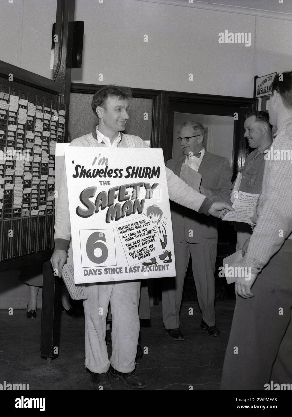 1950s, historical, at the employees entrance at paper mill, by the ...