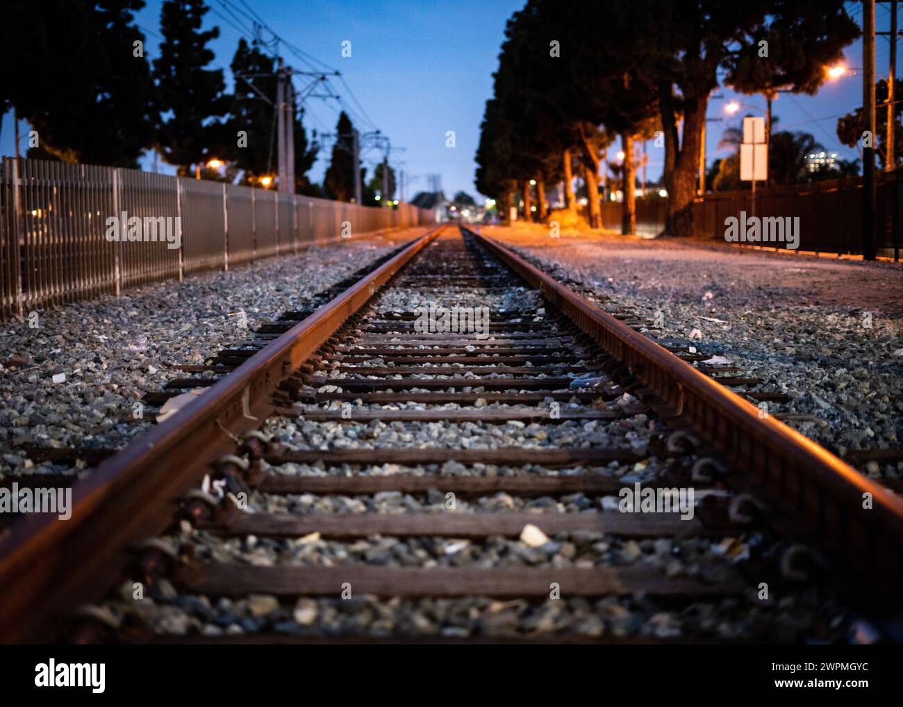 A nighttime shot of train tracks and power lines Stock Photo - Alamy