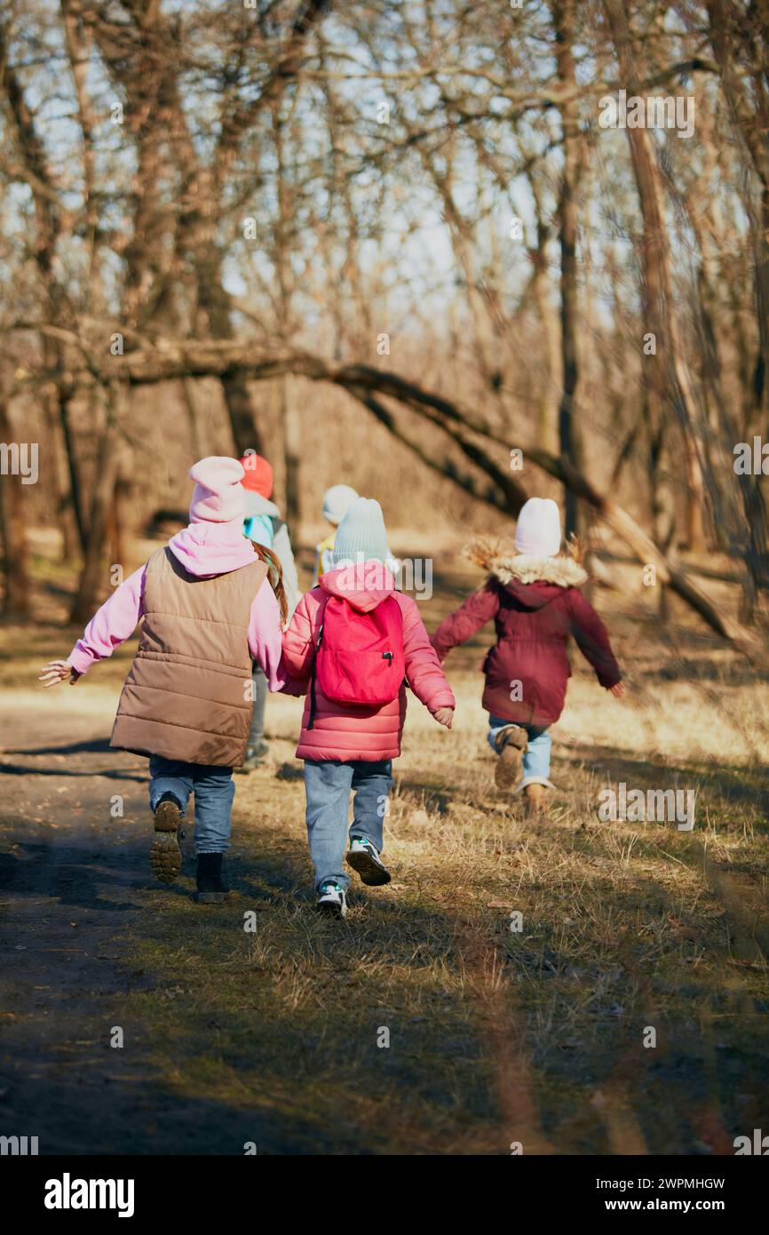 Happy kids, classmates, boys and girls, with backpacks feet walking in ...