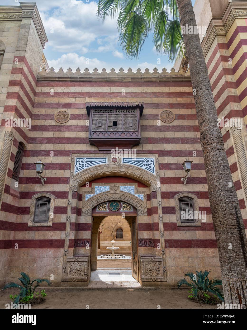 Striking red and white striped arched entrance leads into a Mamluk era ...