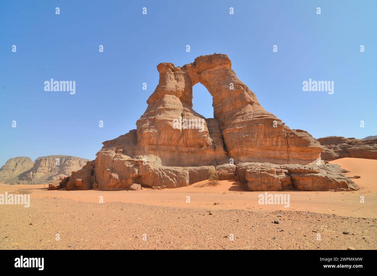 A natural arch formed in sandstone in the Sahara Desert in Algeria ...
