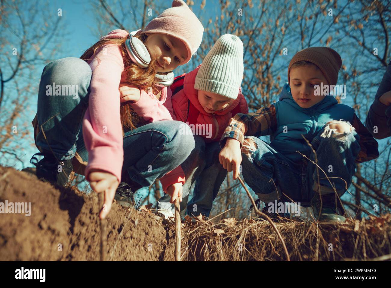 Curious children, classmates examining soil and plants during ...