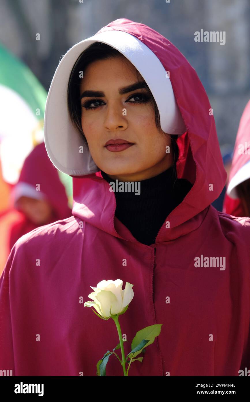 London, UK, 8th March, 2024. British-Iranians dressed in handmaids tale costumes march through ...