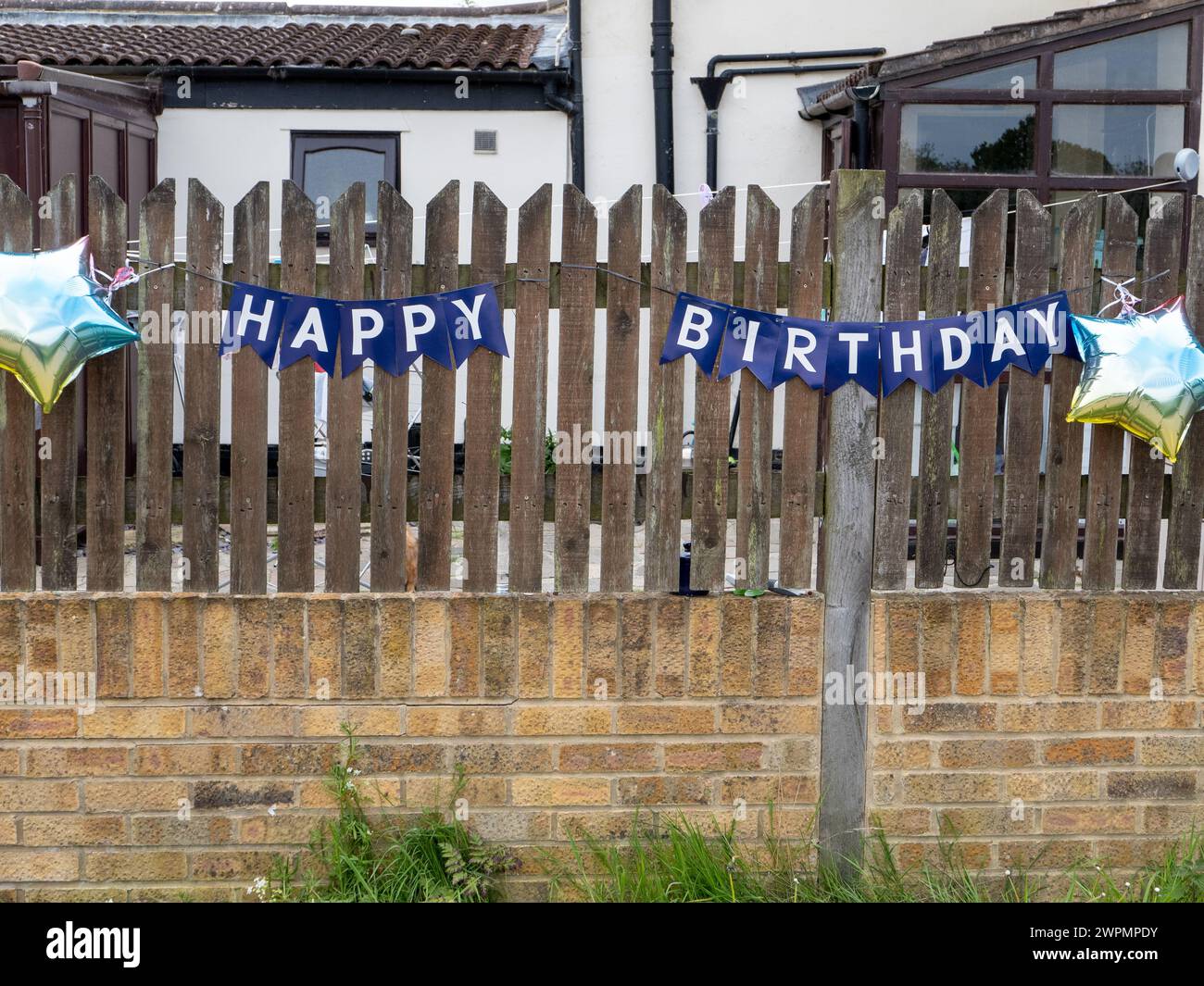 Birthday party balloons outside house hi-res stock photography and ...