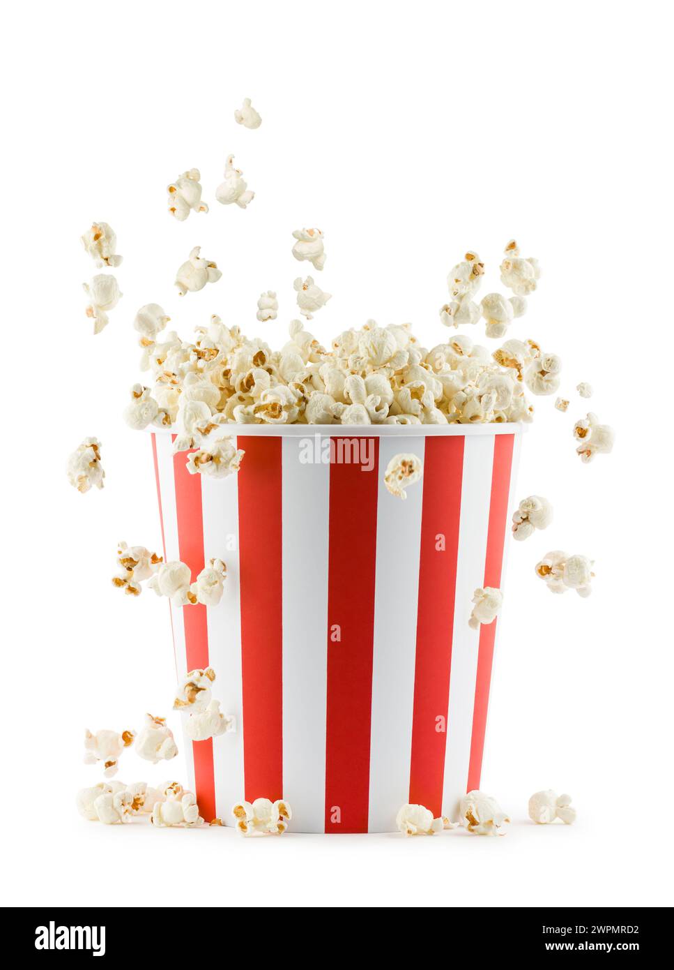 Popcorn falling from red and white striped container, isolated on white ...